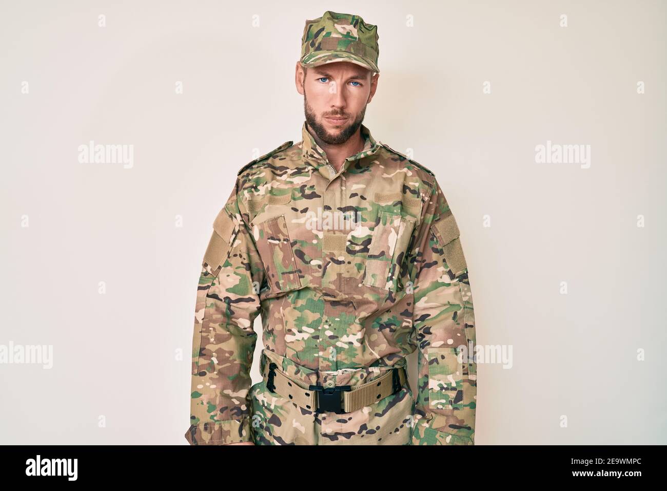 Young caucasian man wearing camouflage army uniform skeptic and nervous ...