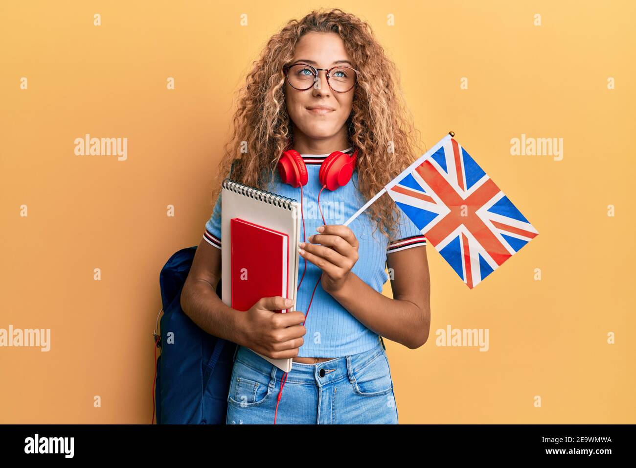 Beautiful caucasian teenager girl exchange student holding uk flag ...