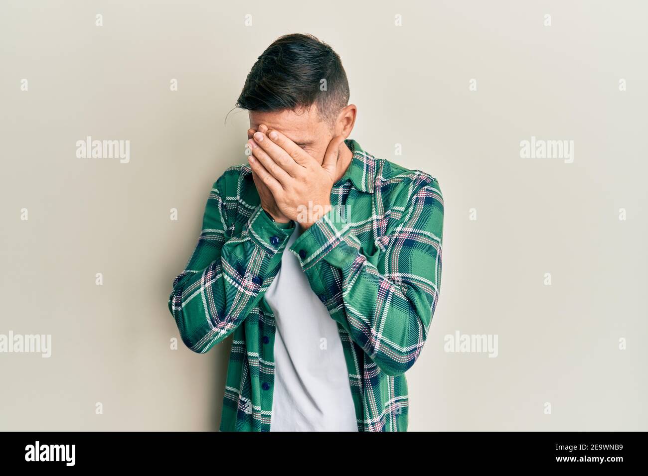 Handsome man with beard wearing casual clothes with sad expression ...