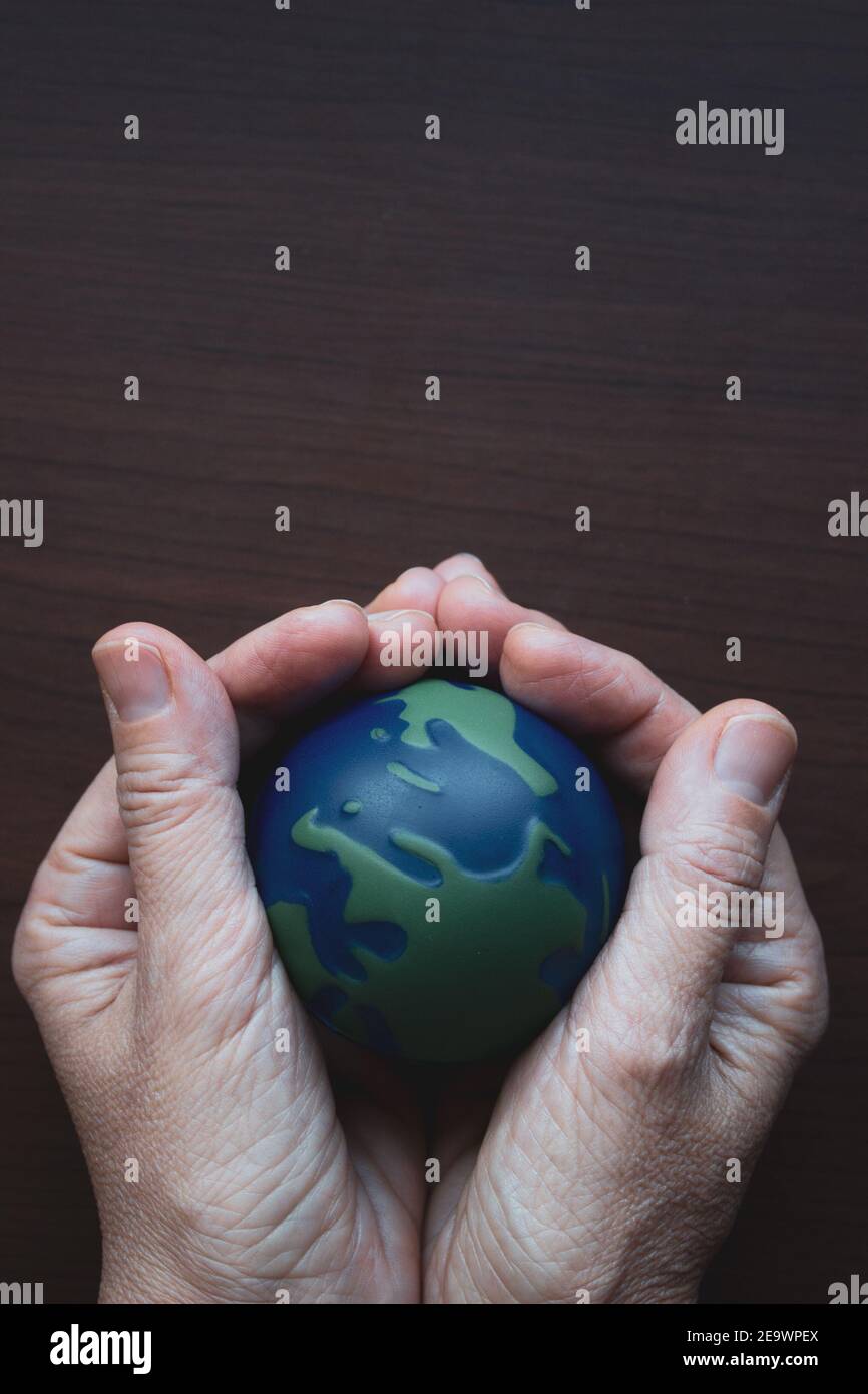 Earth Day. Male hand holding earth in his hands. Human saving planet ...