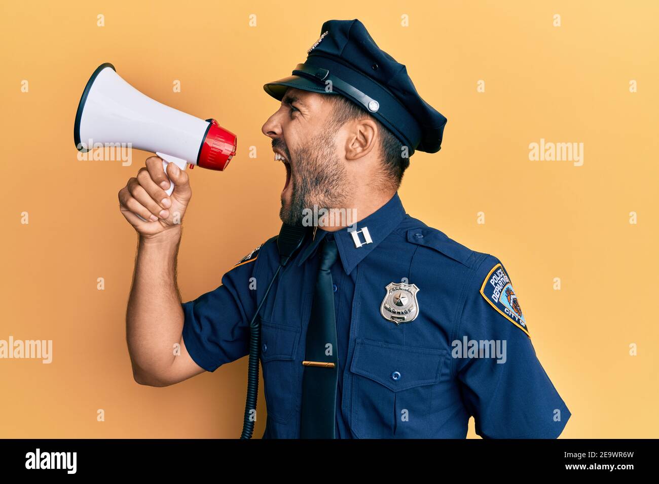 American police officer shouting through megaphone, yelling and ...