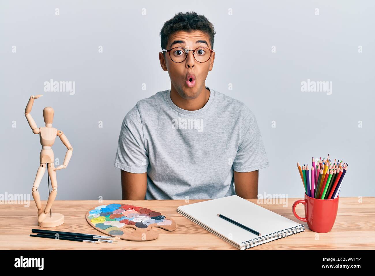 Young handsome african american man painter sitting palette and art ...
