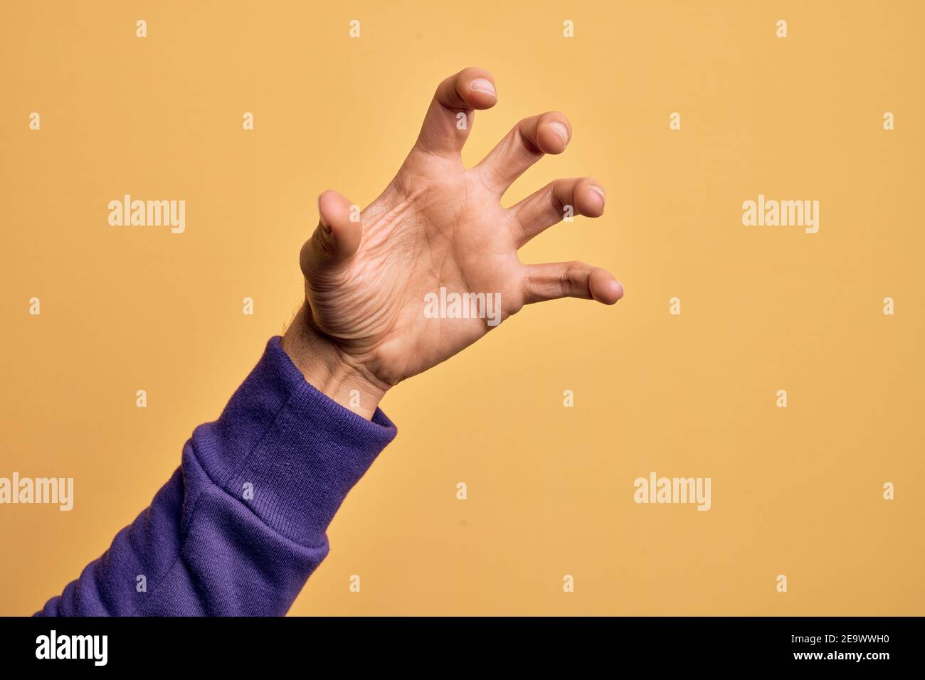 Hand of caucasian young man showing fingers over isolated yellow ...