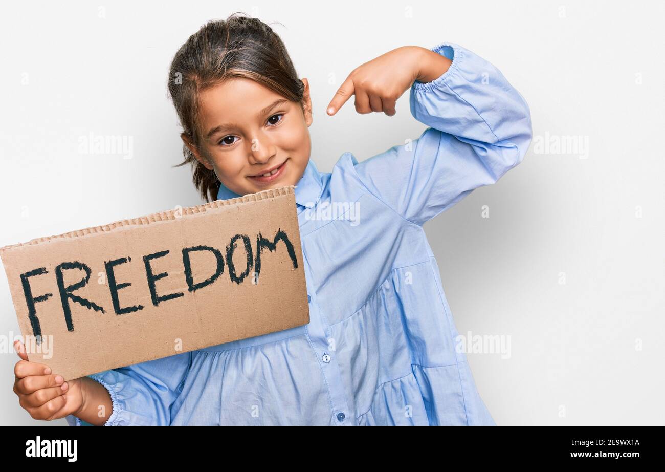 Little beautiful girl holding freedom banner pointing finger to one ...
