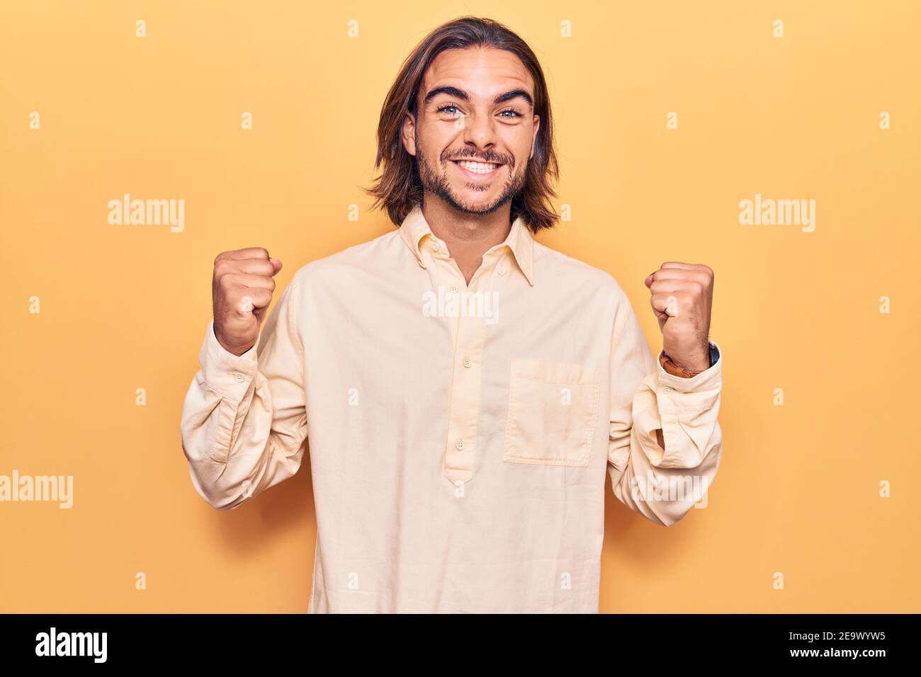 Young handsome man wearing business clothes celebrating surprised and ...