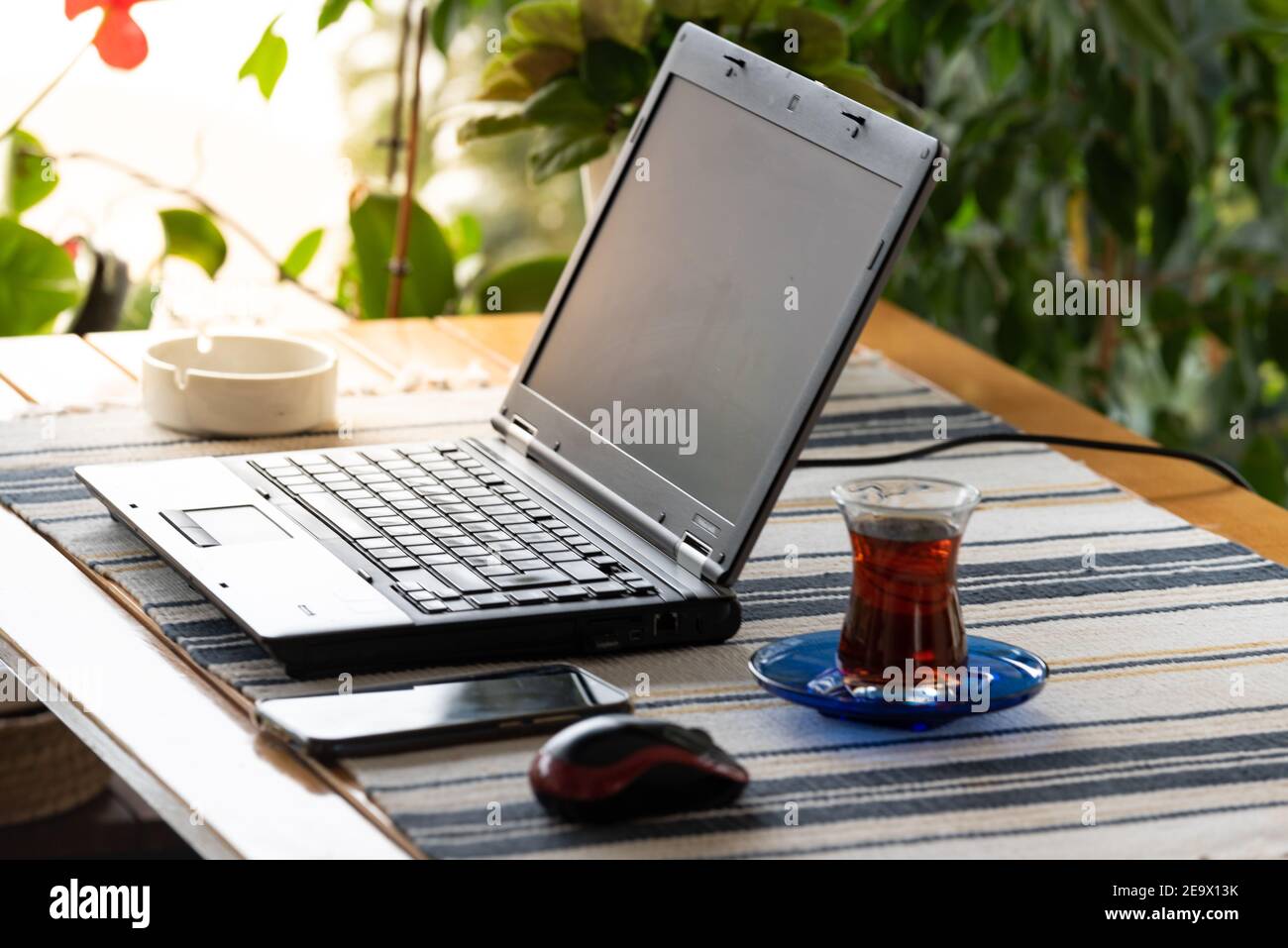 Working at home on a task, with mobile phone, tea and a computer Stock ...
