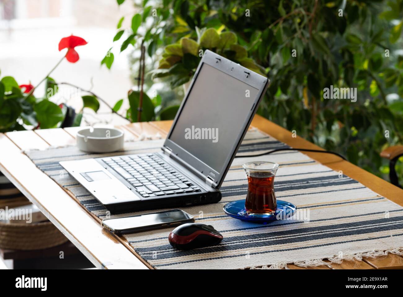 Working at home on a task, with mobile phone, tea and a computer Stock ...