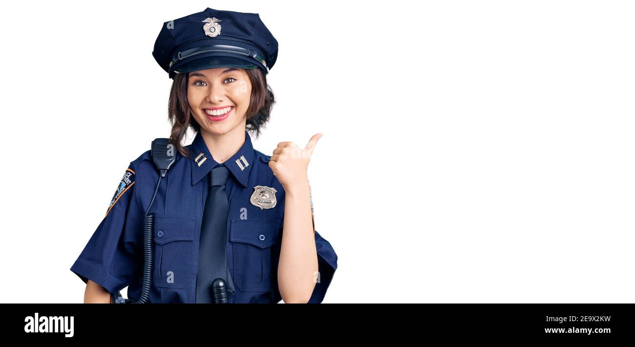 Young beautiful girl wearing police uniform smiling with happy face ...