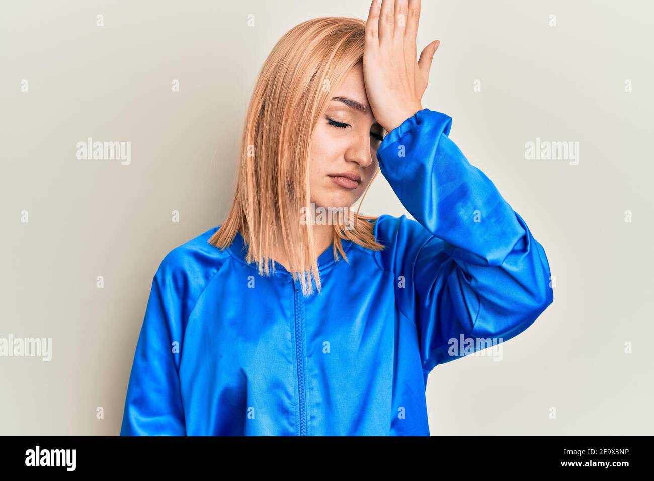 Beautiful Caucasian Woman Wearing Sportswear Surprised With Hand On Head For Mistake Remember