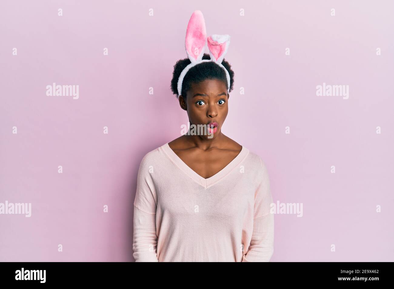 Young african american girl wearing cute easter bunny ears afraid and ...