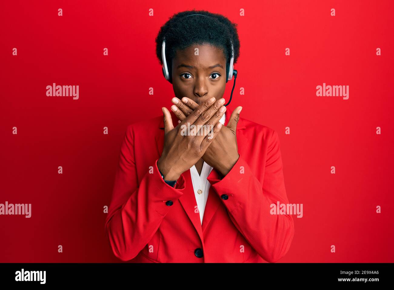 Young african american girl wearing call center agent headset shocked ...