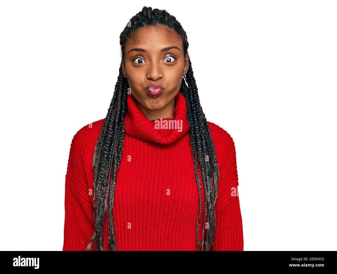 African american woman wearing casual winter sweater puffing cheeks ...