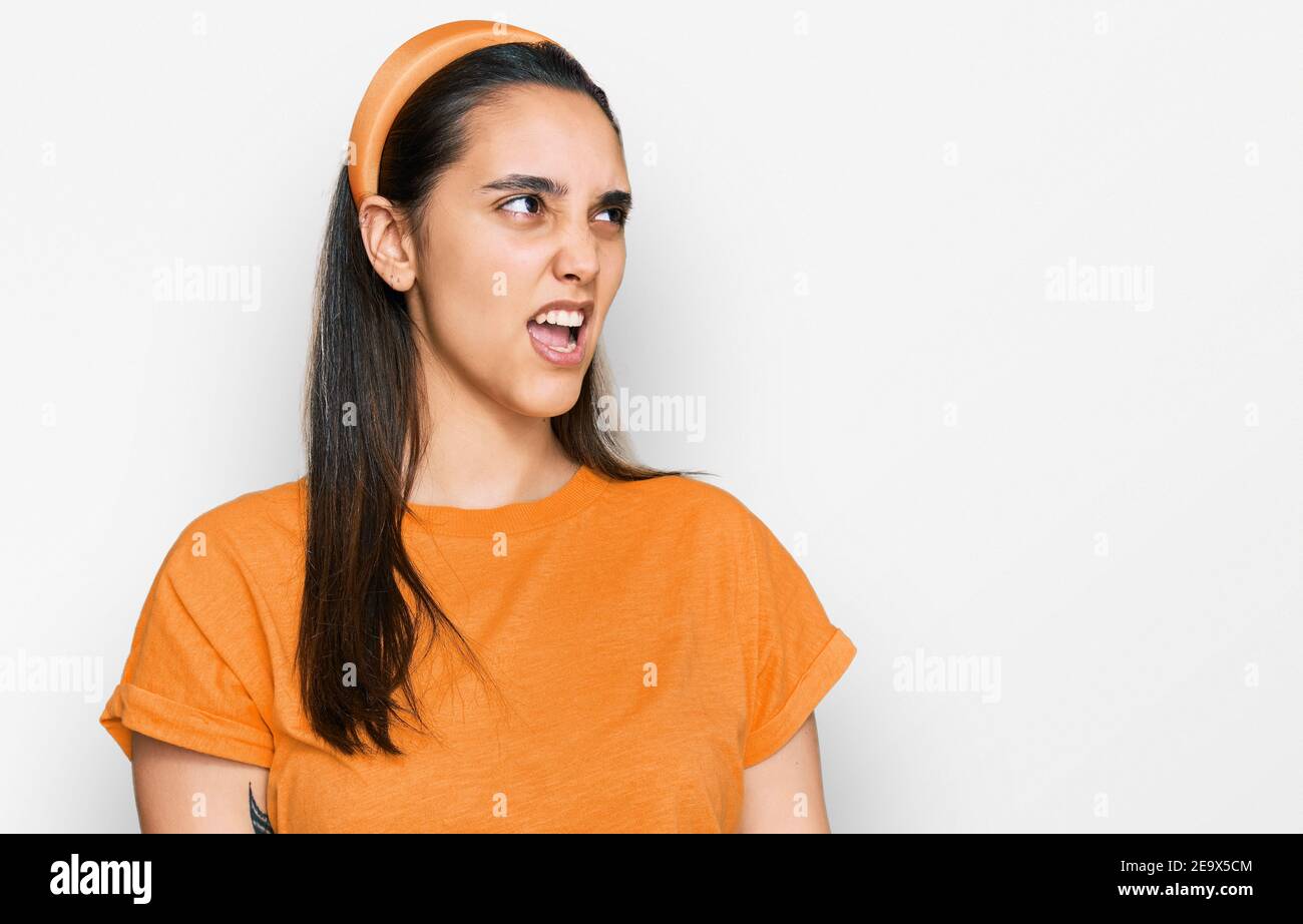 Young hispanic woman wearing casual clothes angry and mad screaming ...