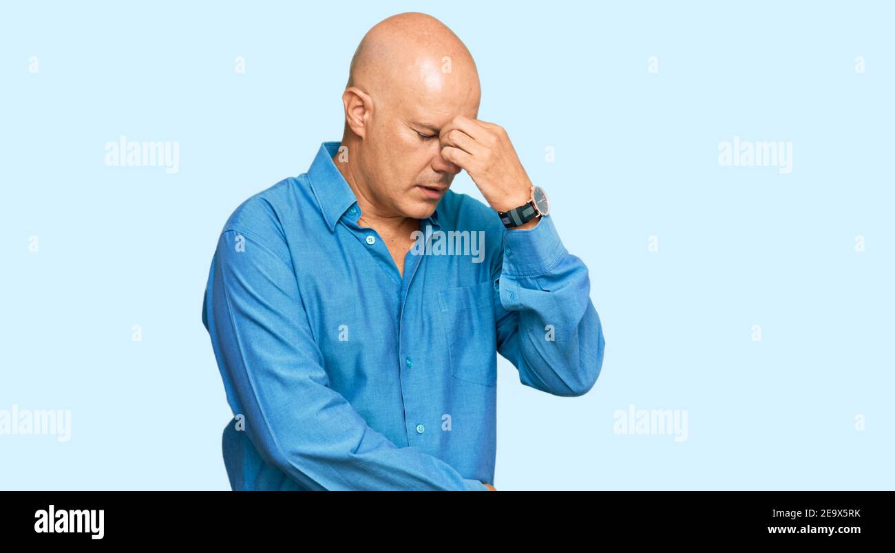 Middle age bald man wearing casual clothes tired rubbing nose and eyes ...