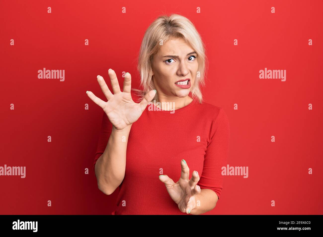 Young blonde girl wearing casual clothes disgusted expression ...