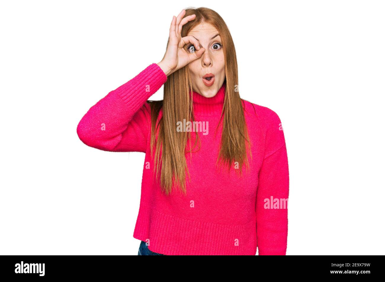 Young irish woman wearing casual clothes doing ok gesture shocked with ...