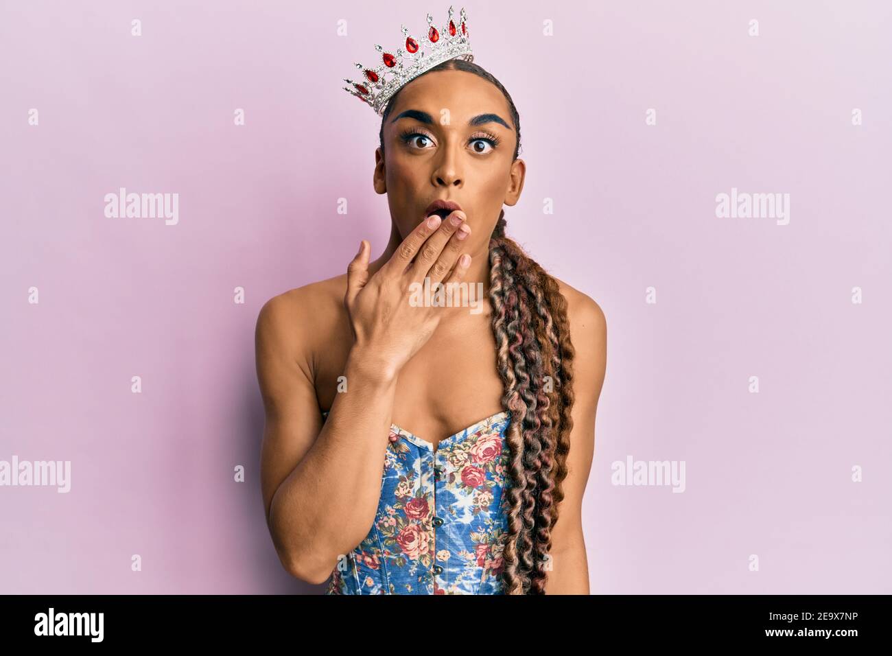 Hispanic man wearing make up and long hair wearing princess crown ...