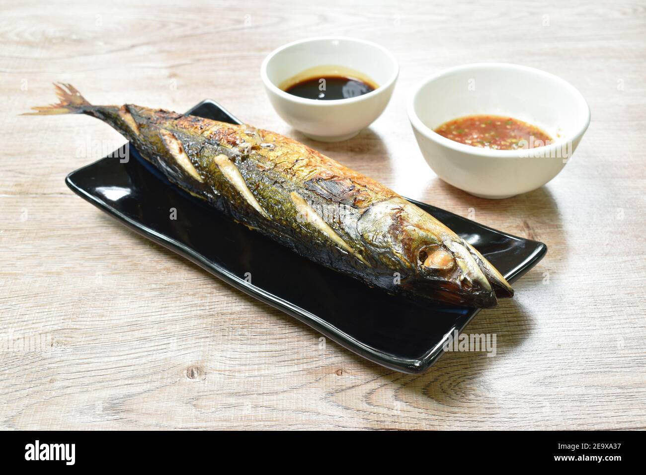 grilled saba fish or mackerel on plate dipping black sweet soybean and ...
