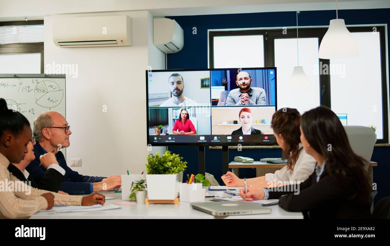 Headshot screen application view of remote multiracial employees ...