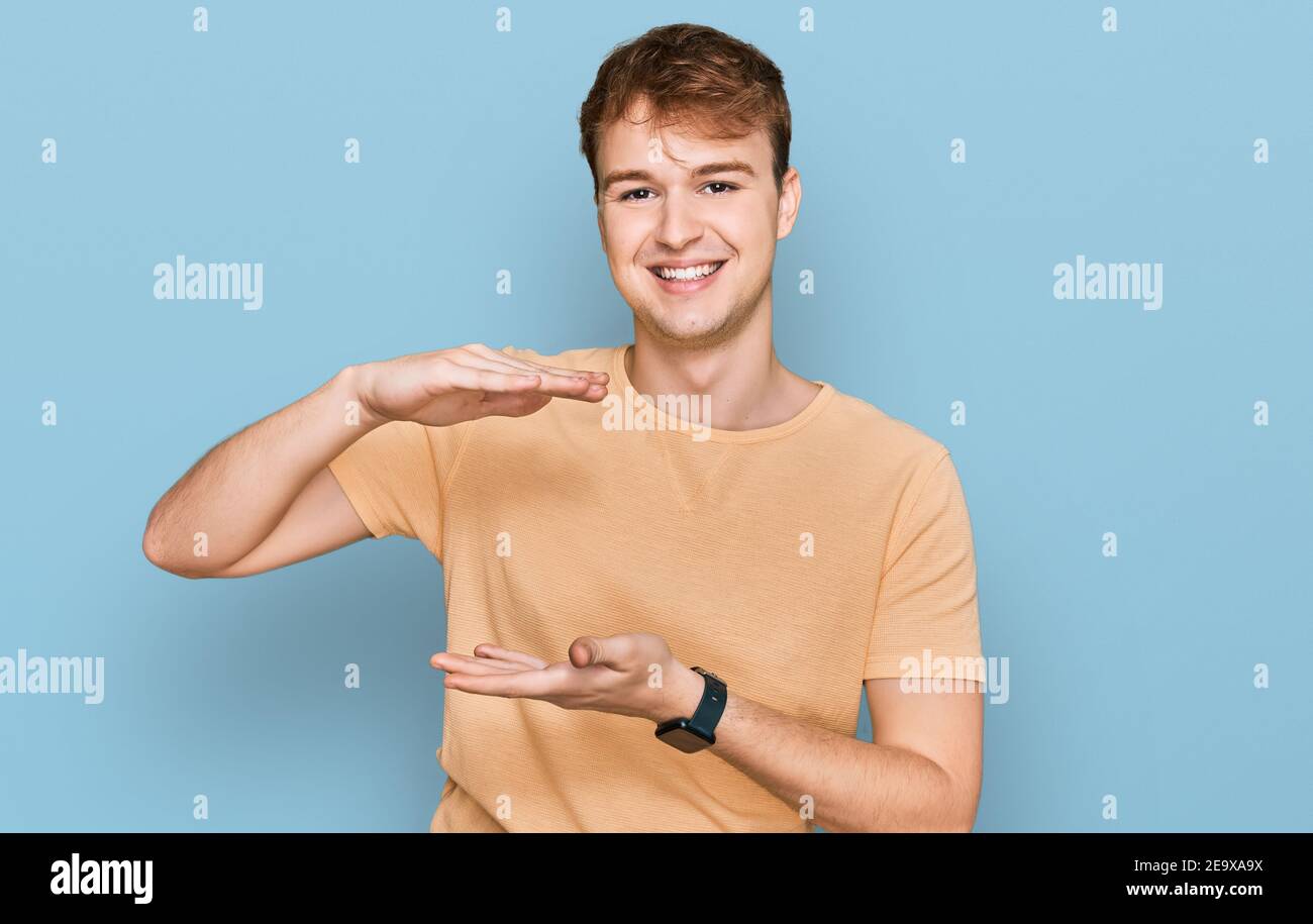 Young caucasian man wearing casual clothes gesturing with hands showing ...