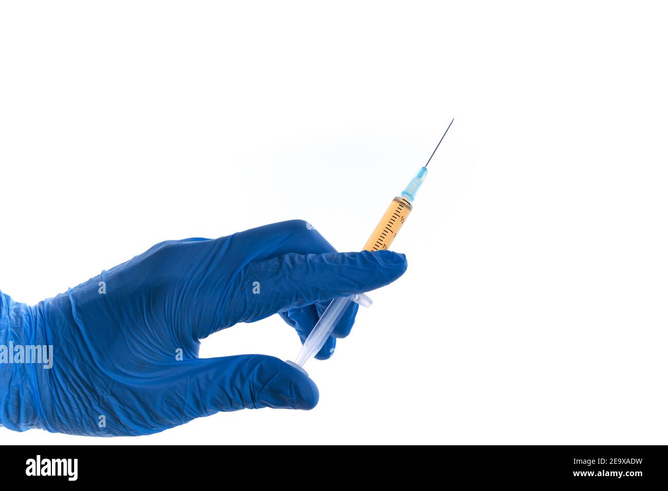 Male hand in blue glove holds syringe isolated on white, copy space ...