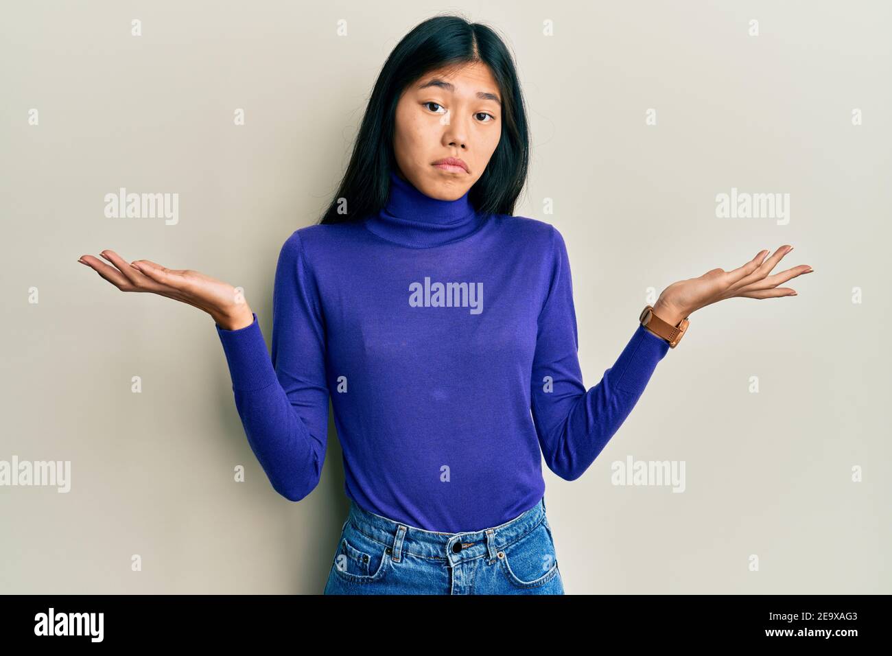 Young chinese woman wearing casual clothes clueless and confused with ...
