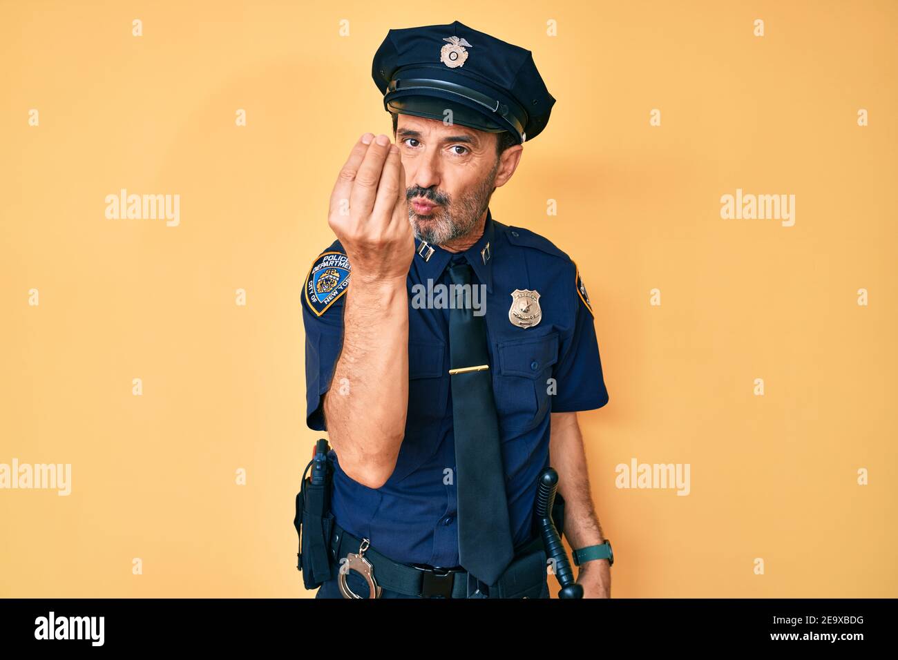 Middle age hispanic man wearing police uniform doing italian gesture ...