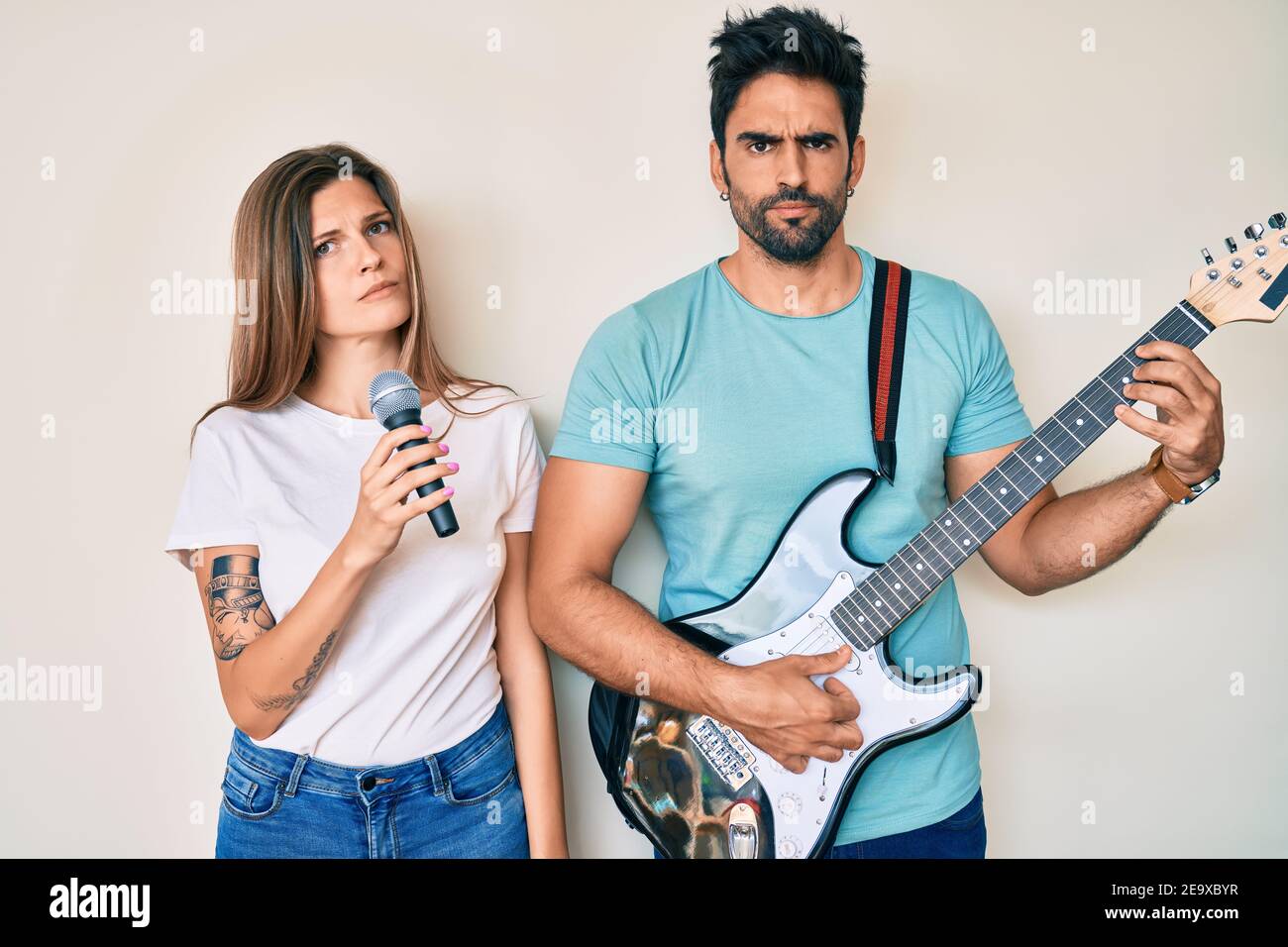 Beautiful young couple of boyfriend and girlfriend singing song using ...