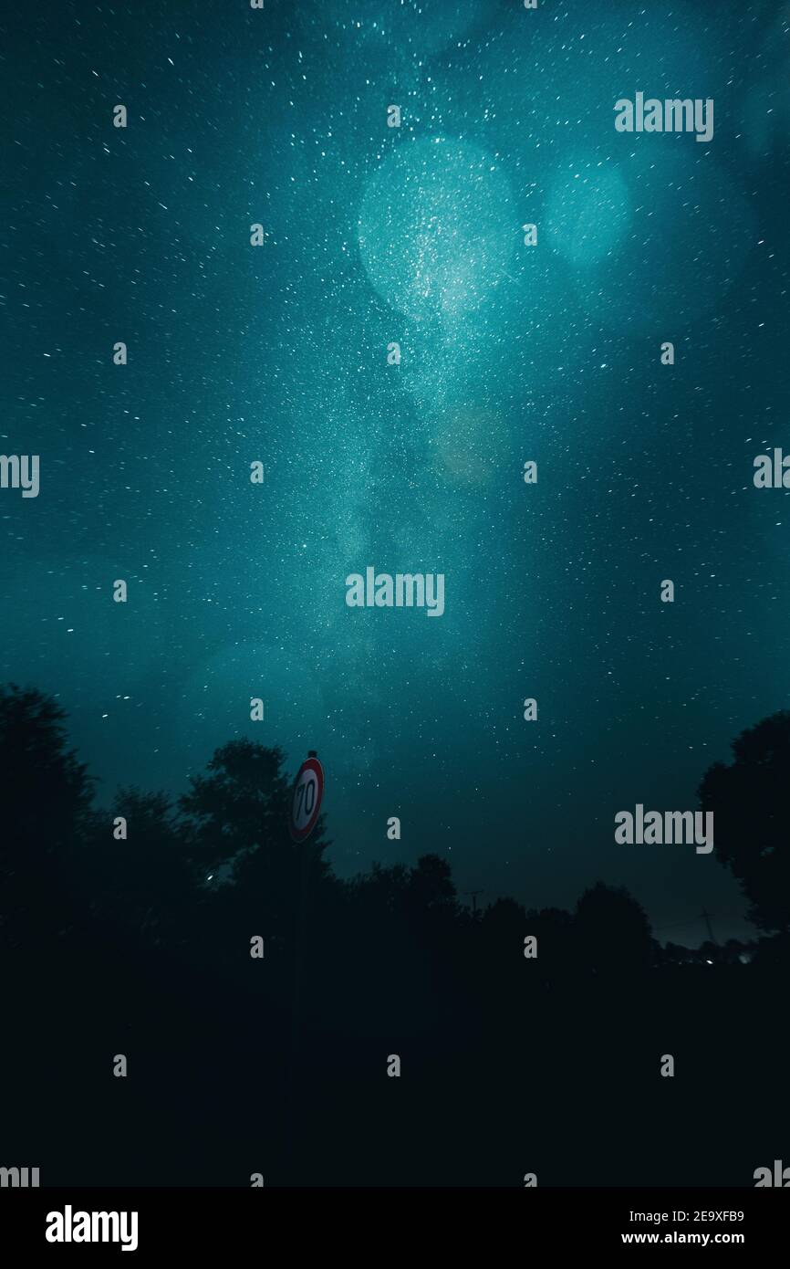 Vertical shot of the Milky Way galaxy in the night sky full of shining ...