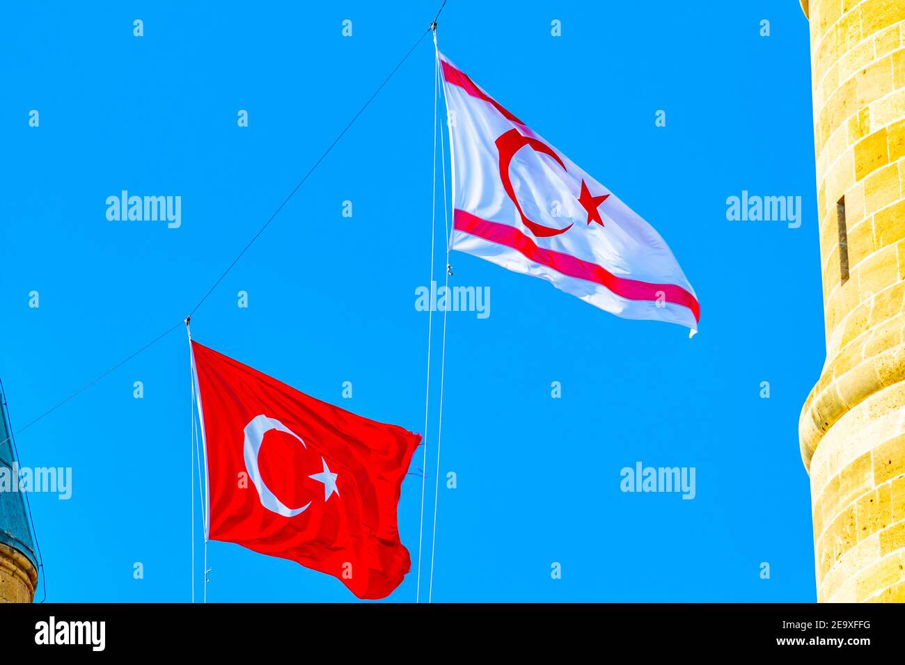 Flags of Turkey and Republic of Northern Cyprus waving between steeples ...