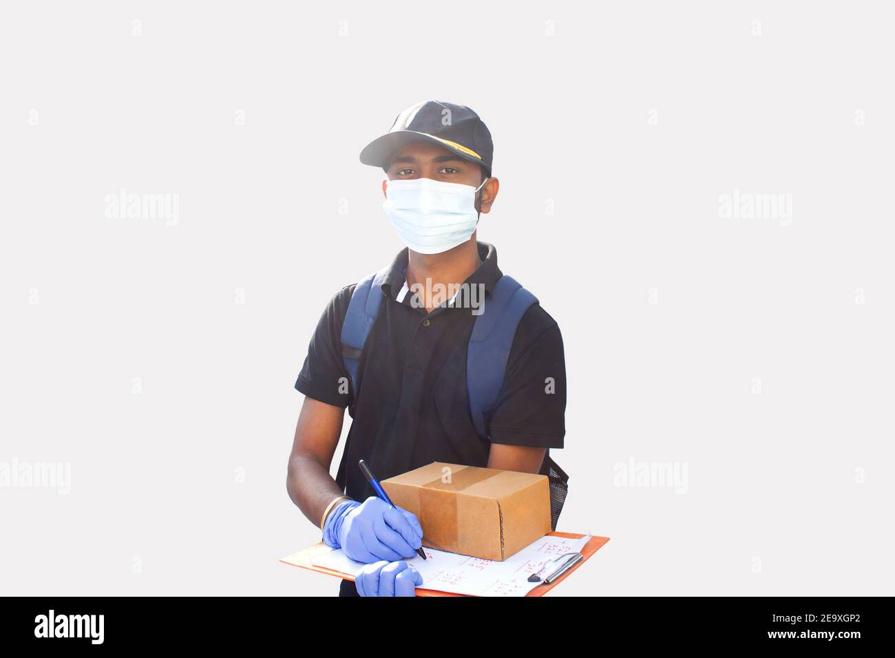 Indian Delivery boy delivering the parcel Stock Photo - Alamy
