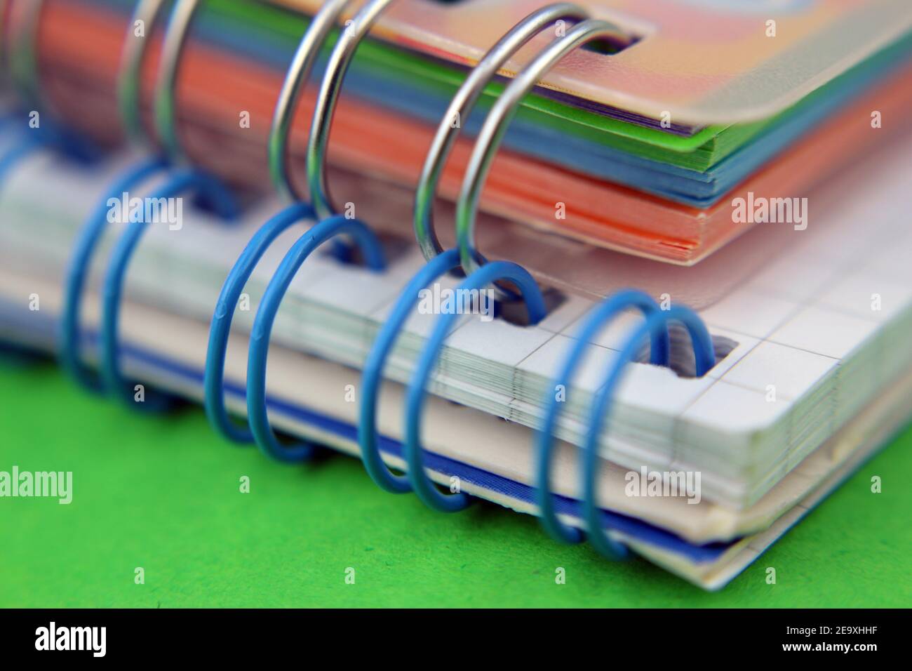 Spiral binder, colorful sheet notebook, foreground, green background ...