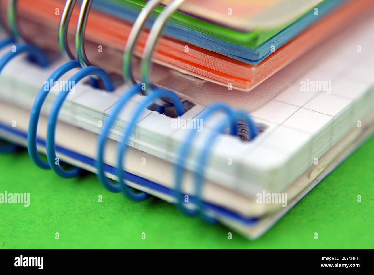 Spiral binder, colorful sheet notebook, foreground, green background ...