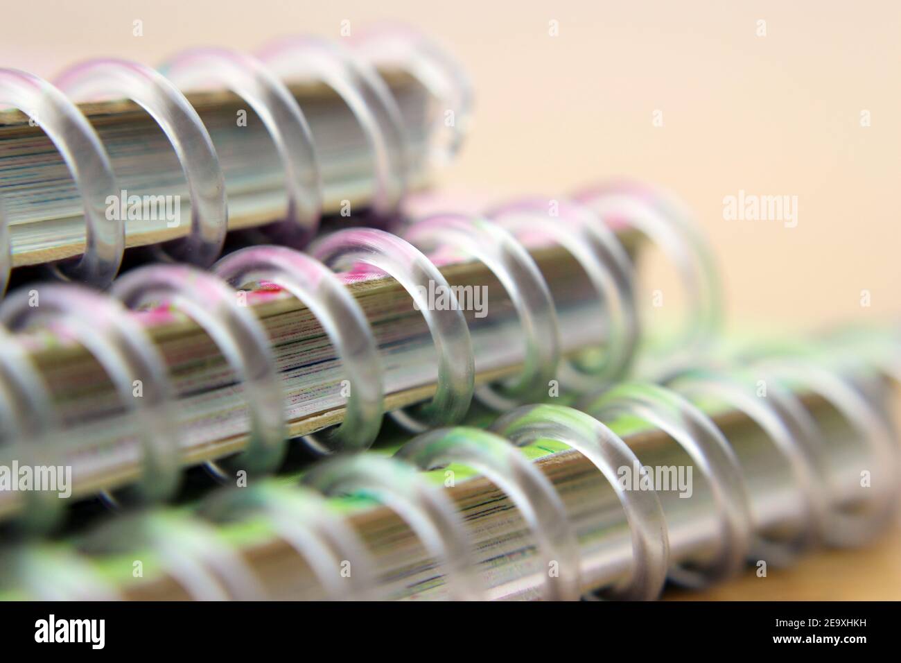 Spiral binder, three notebooks in the foreground, desk background Stock ...