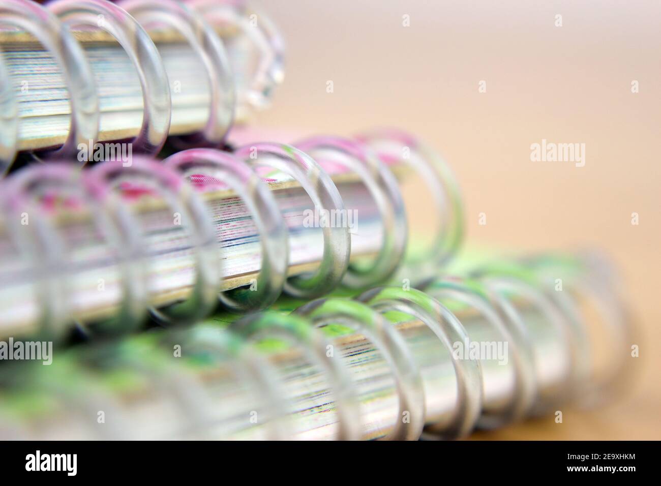 Spiral binder, three notebooks in the foreground, desk background Stock ...