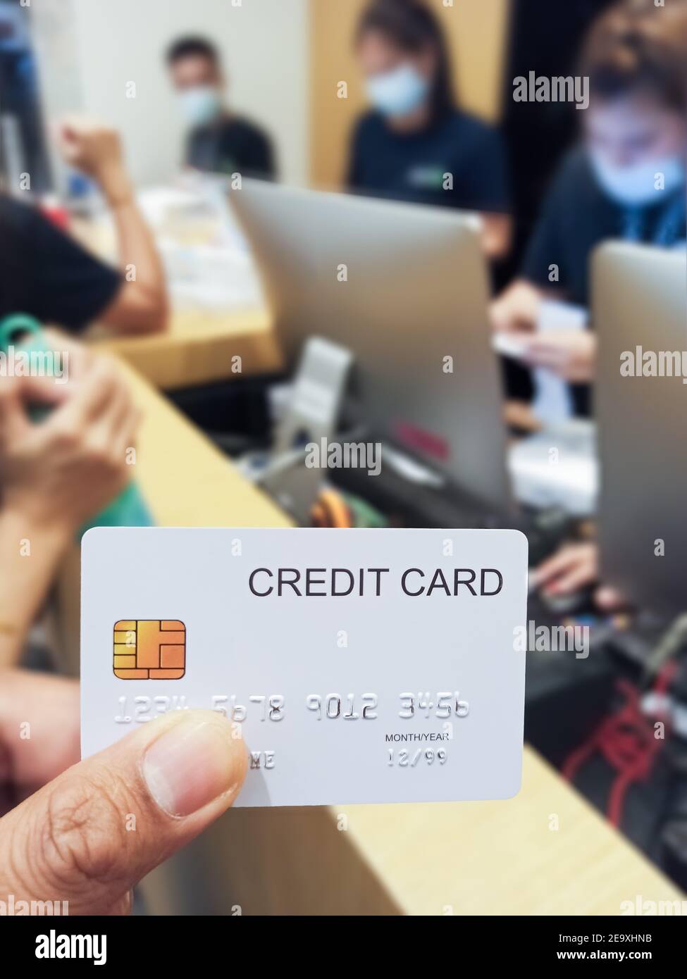 Hand holding credit card in department store over the shop store ...