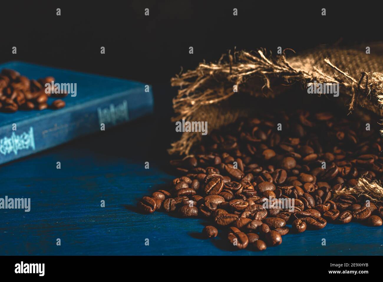 Roasted coffee beans on a navy blue background Stock Photo - Alamy