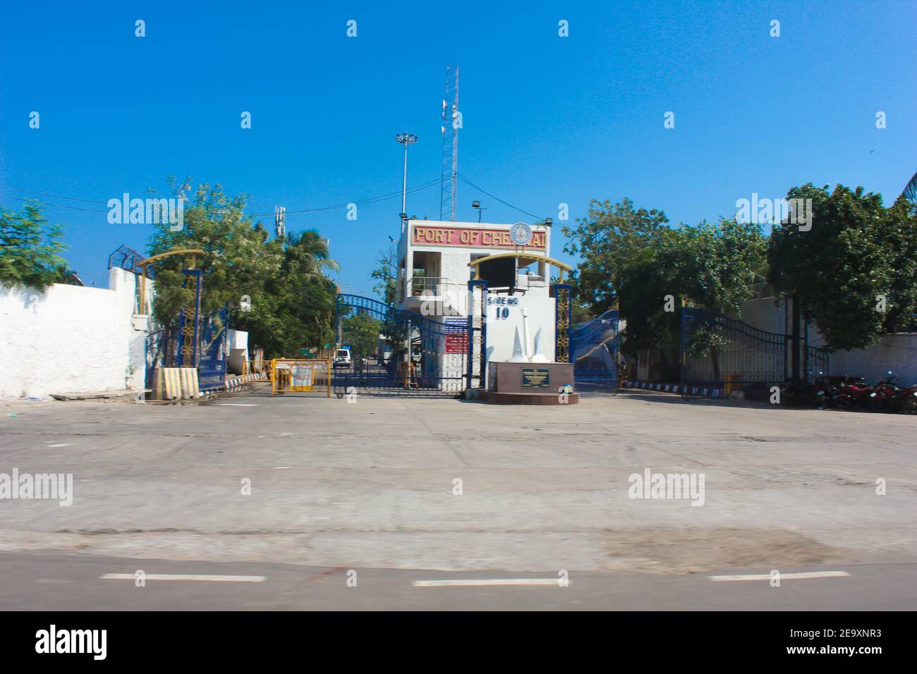 The gates of the Port of Chennai, India. People and traffic move about ...