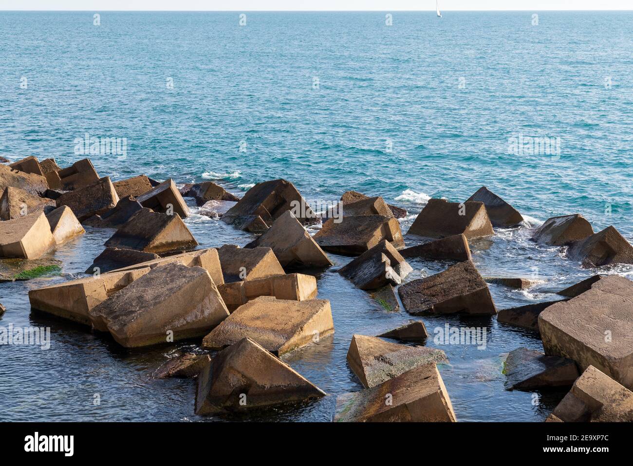 Artificial rocks forming a breakwater. Mediterranean sea, a sunny ...