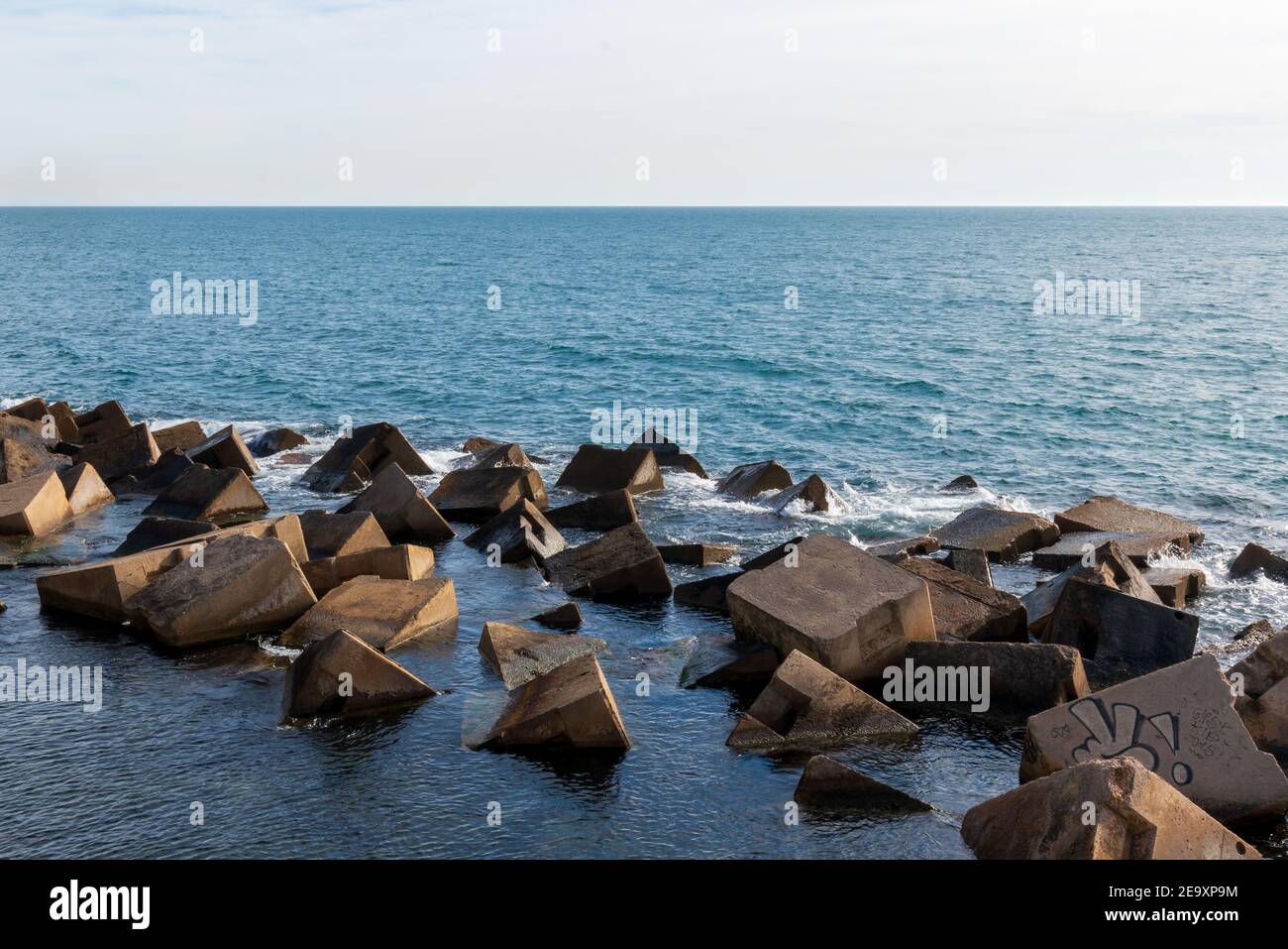 Artificial rocks forming a breakwater. Mediterranean sea, a sunny ...