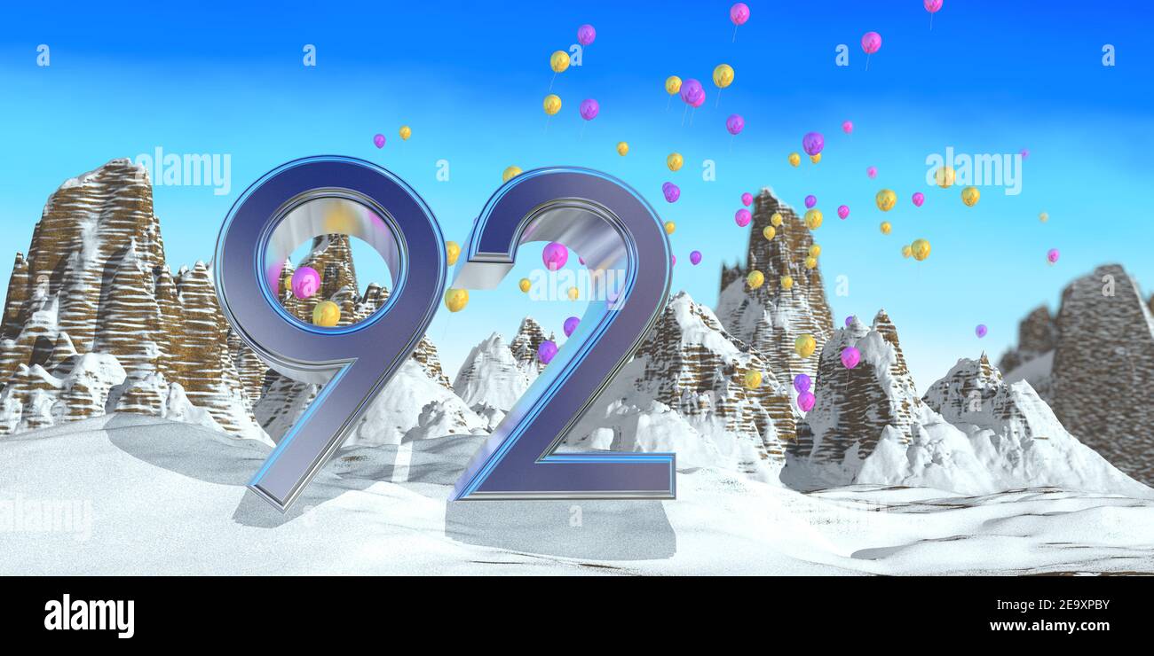 Number 92 in thick blue font on a snowy mountain with rock mountains ...