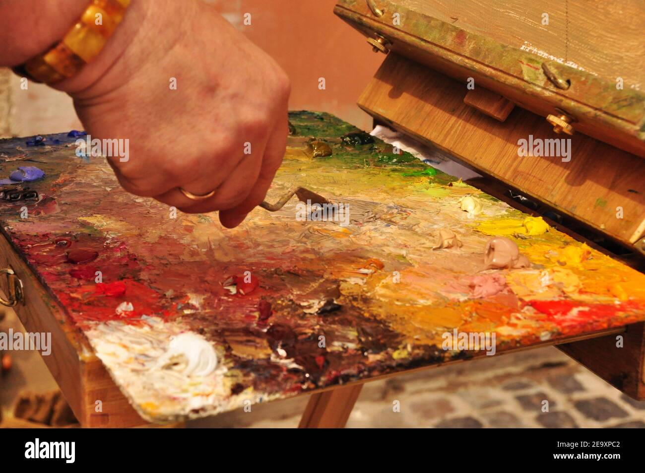 Crop hand of painter mixing and blending different colors on palette ...