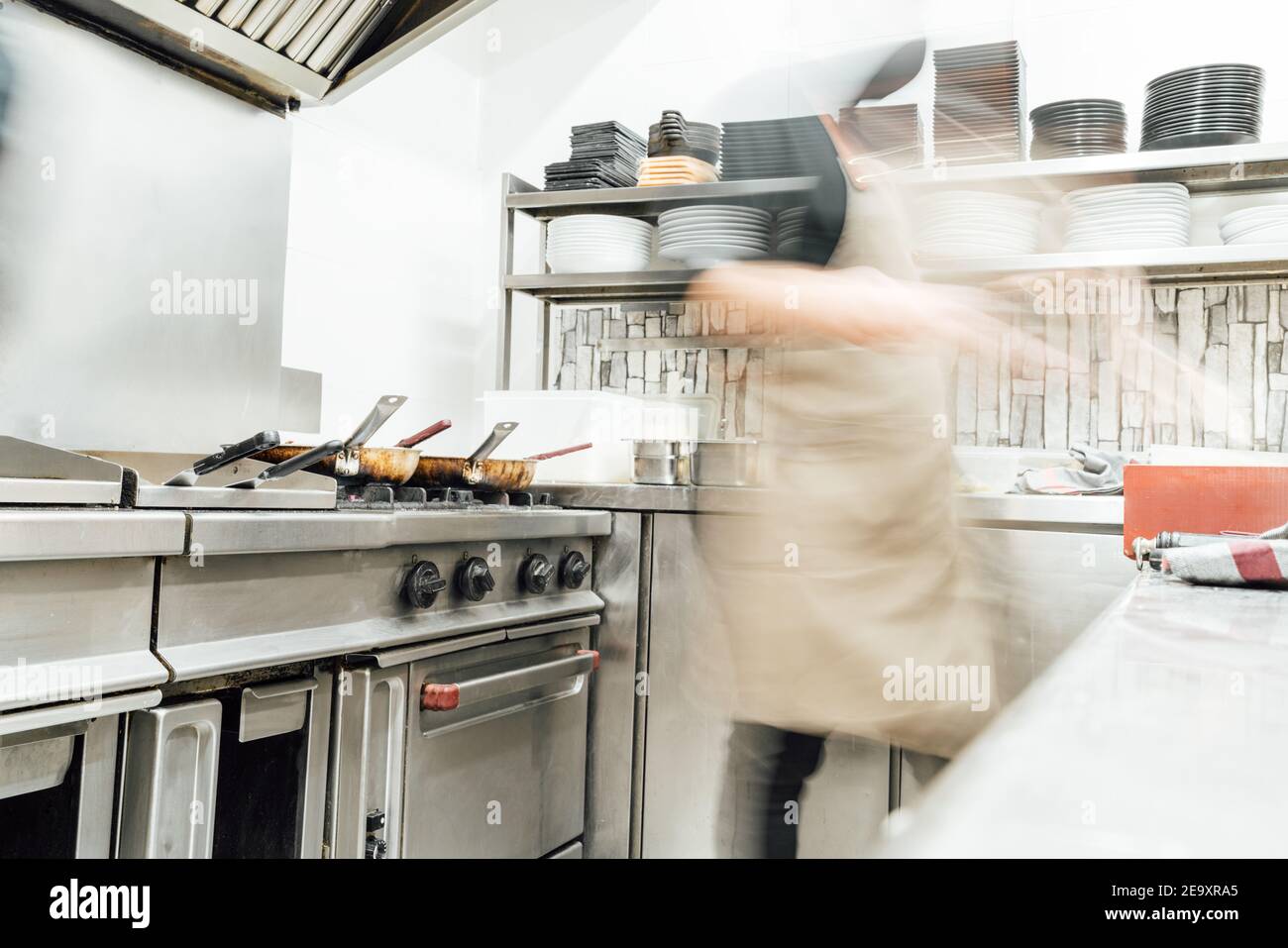Blurred unrecognizable cook preparing food while working in ...
