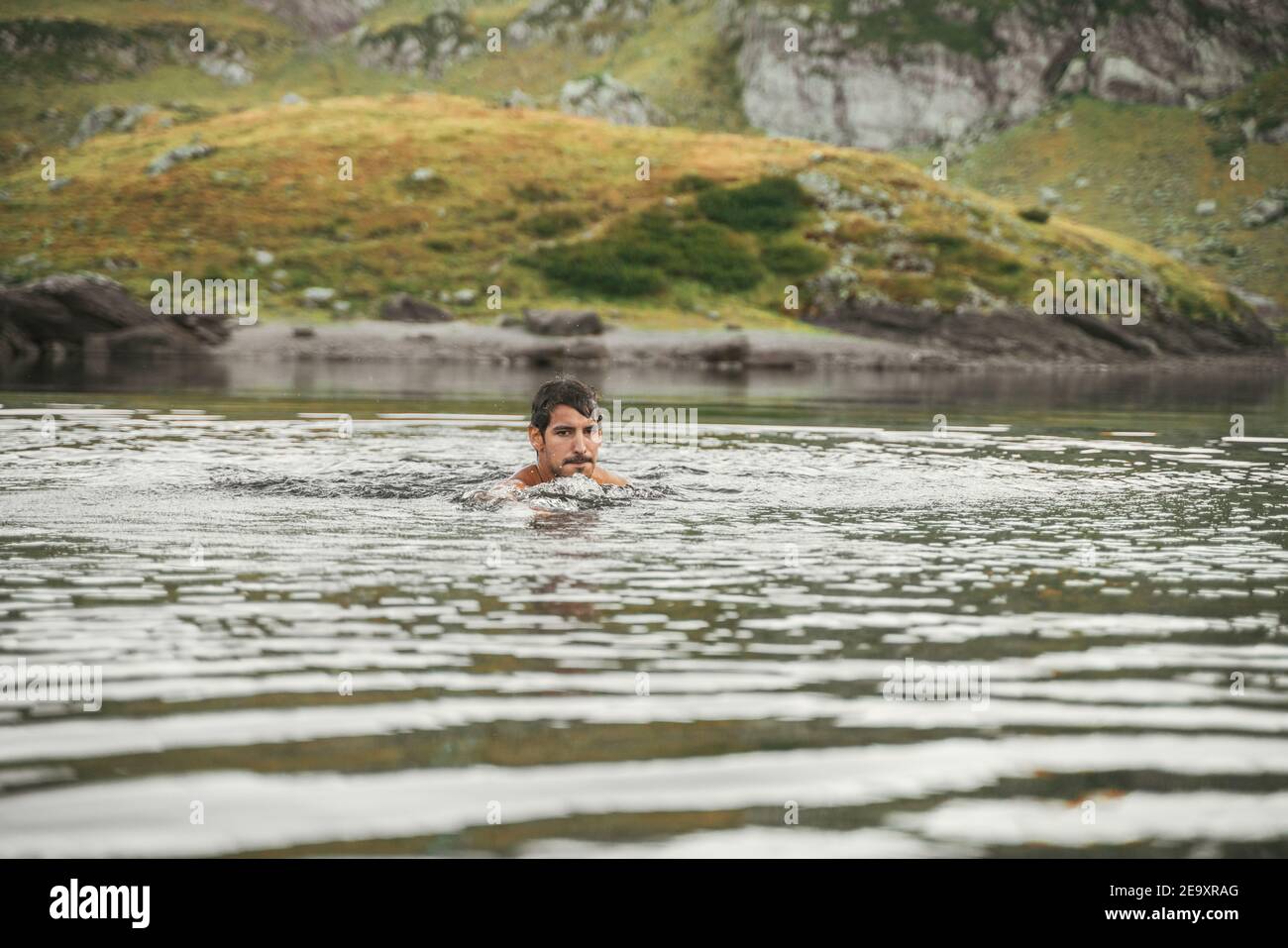 Adult female attaching handle to resistance spring while preparing for ...