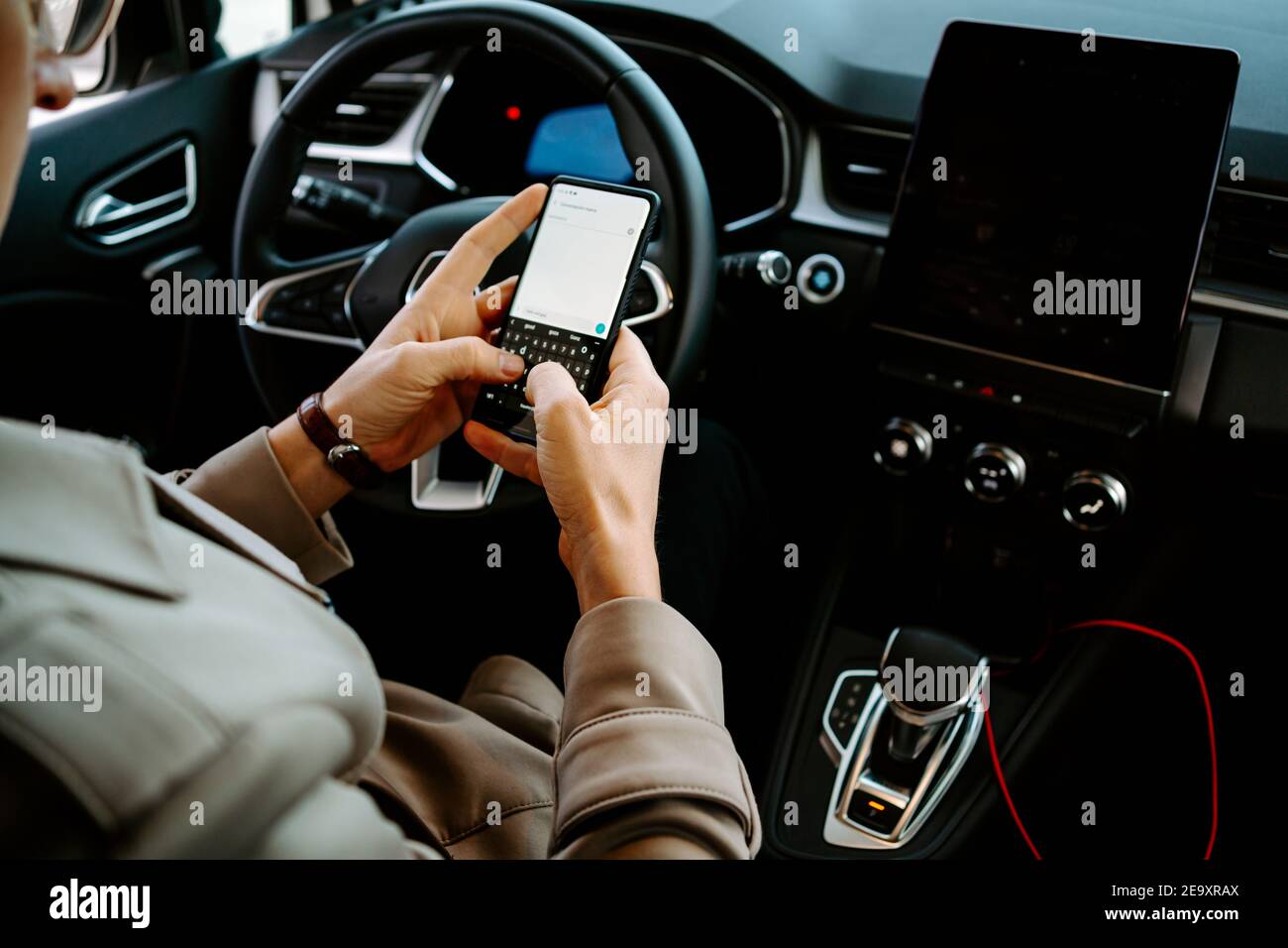 Crop unrecognizable male entrepreneur sitting on driver seat in luxury ...