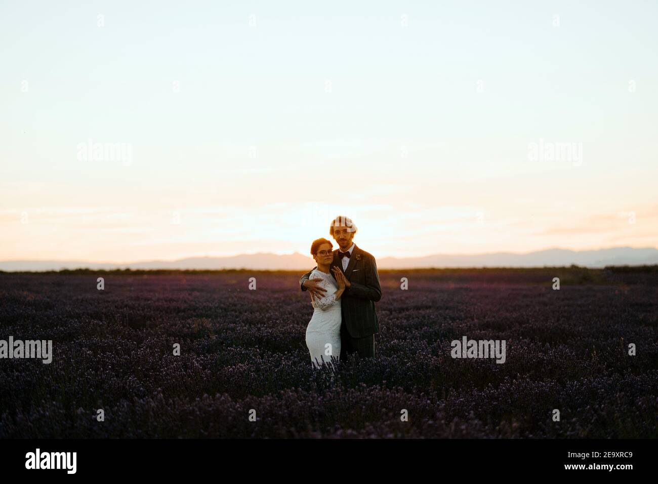 Side view of romantic newlywed couple standing face to face on spacious ...