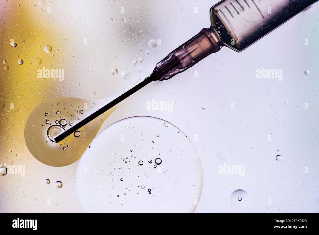 Closeup of needle of syringe filled with vaccine from virus injected in ...