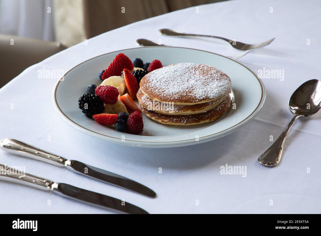 From above plate of tasty pancakes with sugar powder served with ...