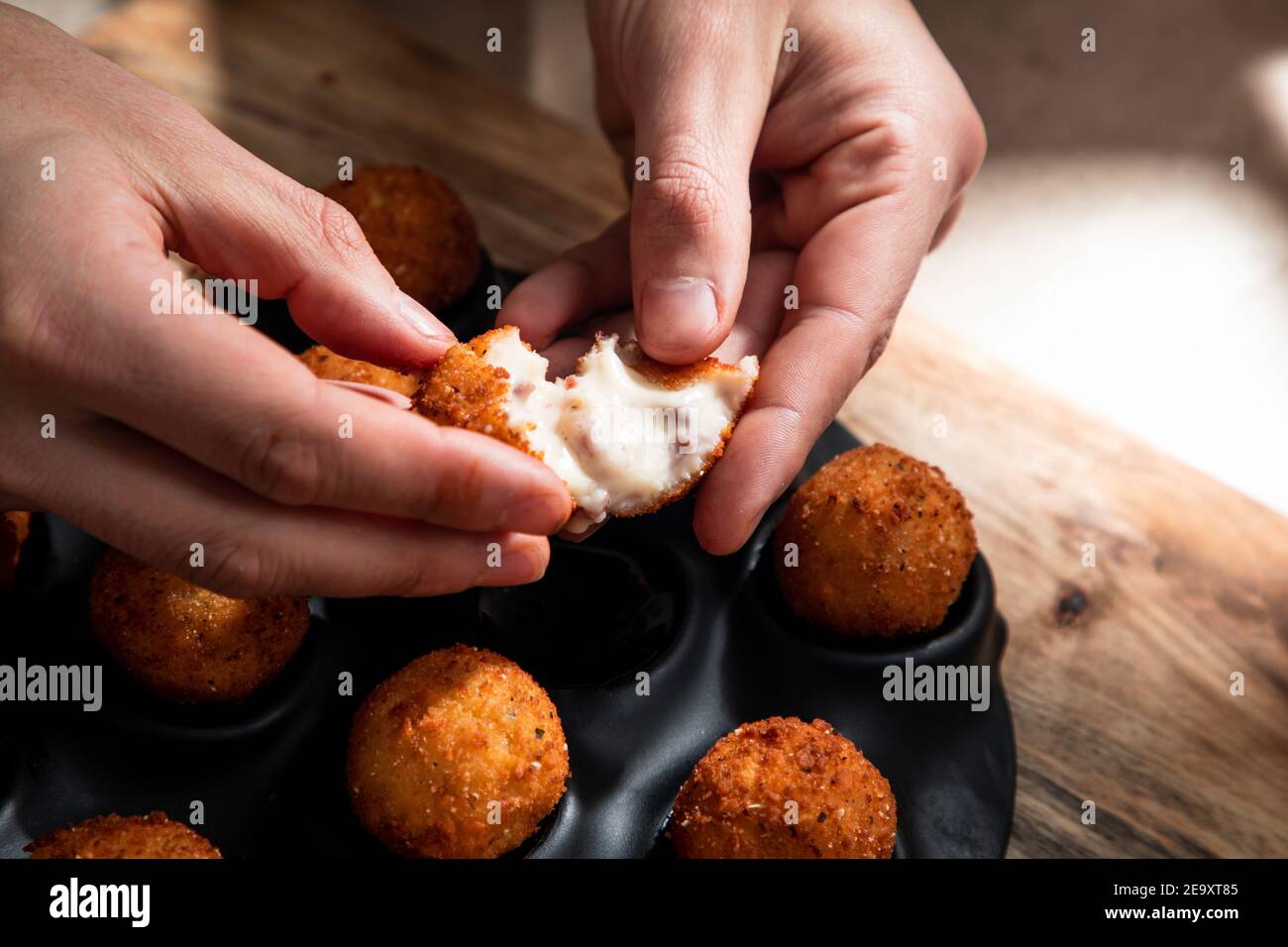 From above of crop anonymous chef demonstrating filling of cheese ball ...