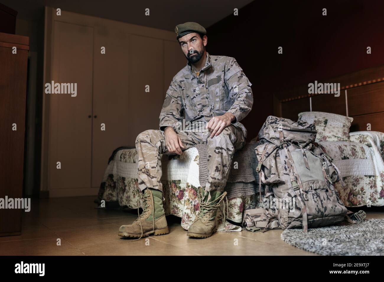 Low angle of serious man in military uniform preparing for serve in ...